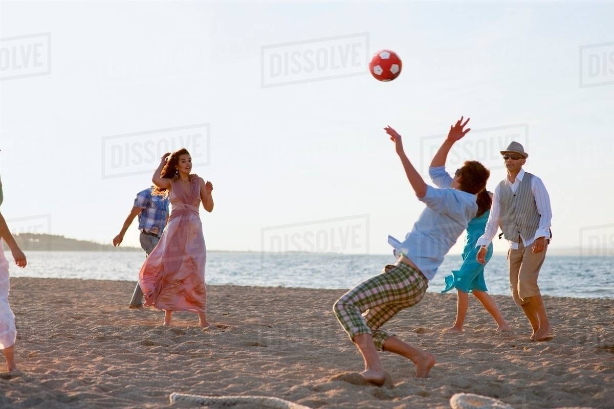 People playing with soccer ball on beach - Royalty-free Stock Photo ...
