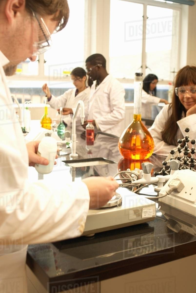 Scientist using scale in lab - Stock Photo - Dissolve