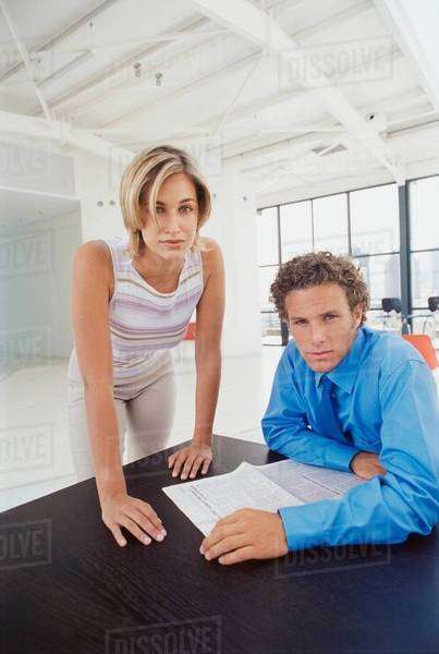 Business people at desk in office - Stock Photo - Dissolve