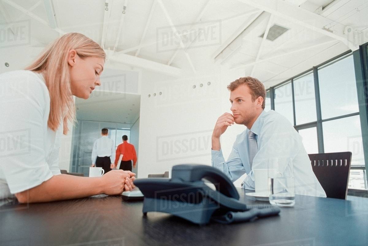 Business people talking at desk - Royalty-free Stock Photo | Dissolve