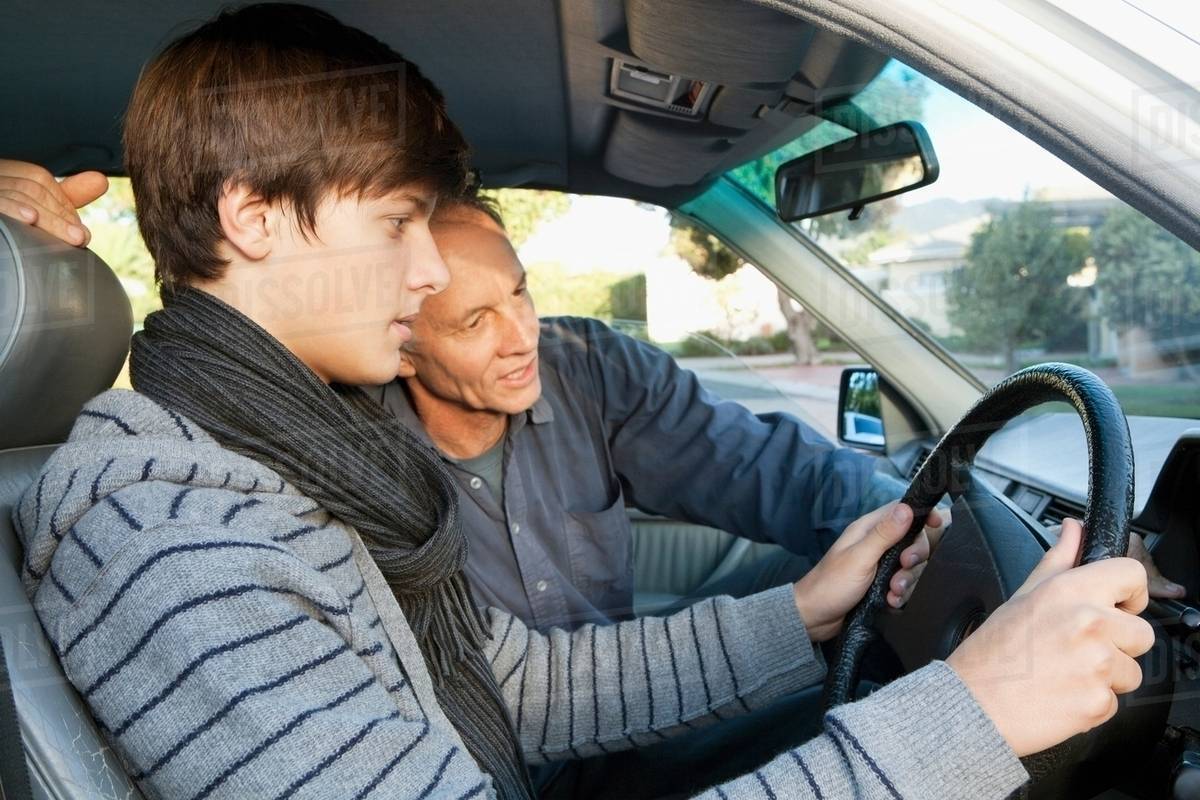 Father teaching son to drive - Royalty-free Stock Photo | Dissolve