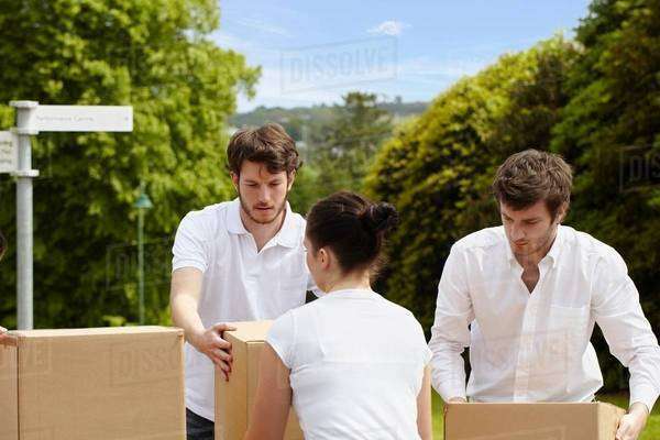People stacking cardboard boxes - Royalty-free Stock Photo | Dissolve