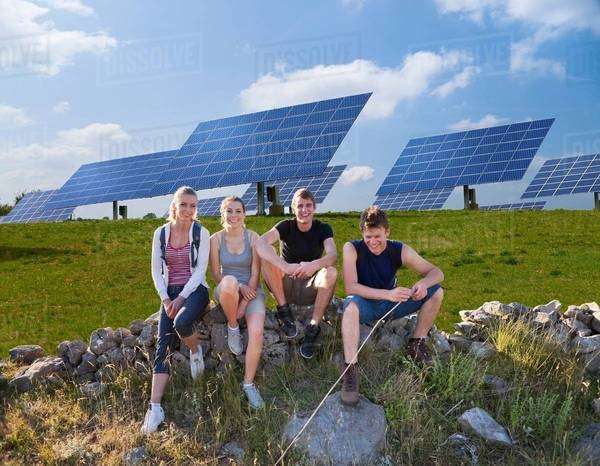 People sitting on wall by solar panels - Royalty-free Stock Photo ...