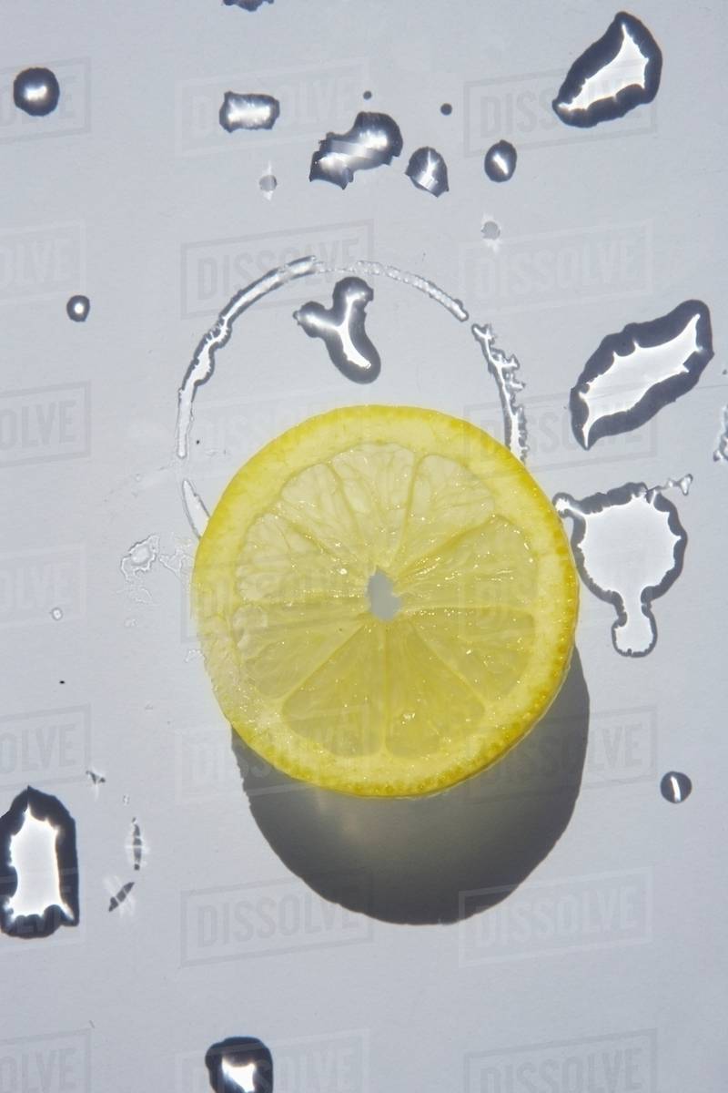Lemon slice and water droplets - Royalty-free Stock Photo | Dissolve