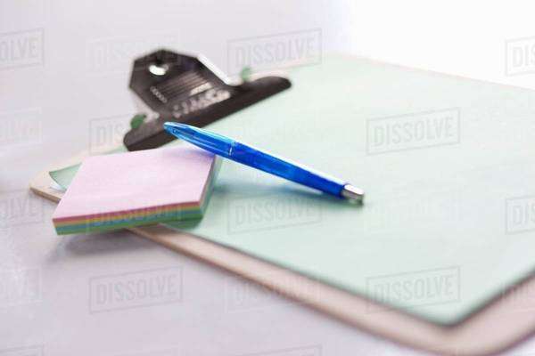 Clipboard, post-it notes, and pen - Royalty-free Stock Photo | Dissolve