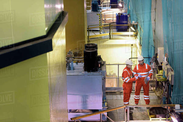 Workers in hydroelectric power station - Stock Photo - Dissolve