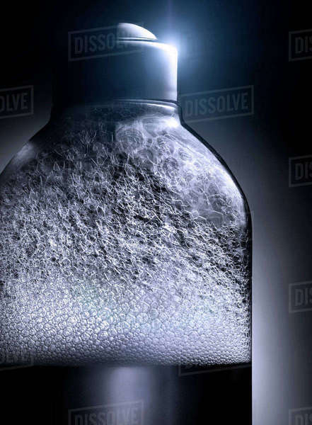 Transparent liquid and foam in glass bottle - Royalty-free Stock Photo ...