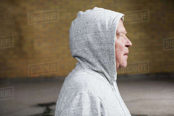 Side view of man wearing hooded top looking away - Royalty-free Stock ...