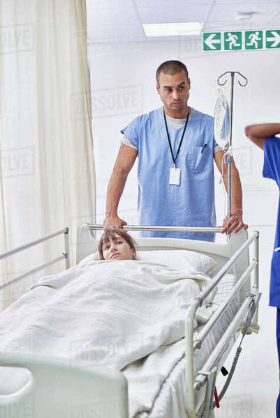 Nurse pushing patient in hospital bed - Royalty-free Stock Photo | Dissolve