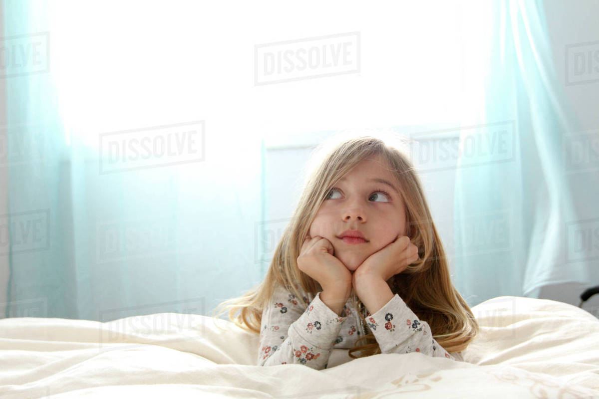 Girl daydreaming in bed - Royalty-free Stock Photo | Dissolve