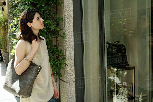 Female shopper looking at shop window, Milan, Italy - Stock Photo ...