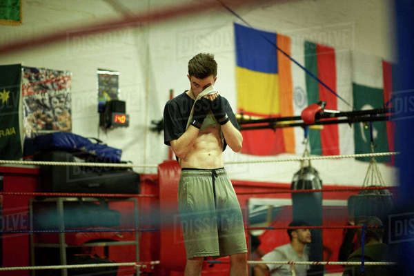 Boxer exercising in boxing ring - Stock Photo - Dissolve