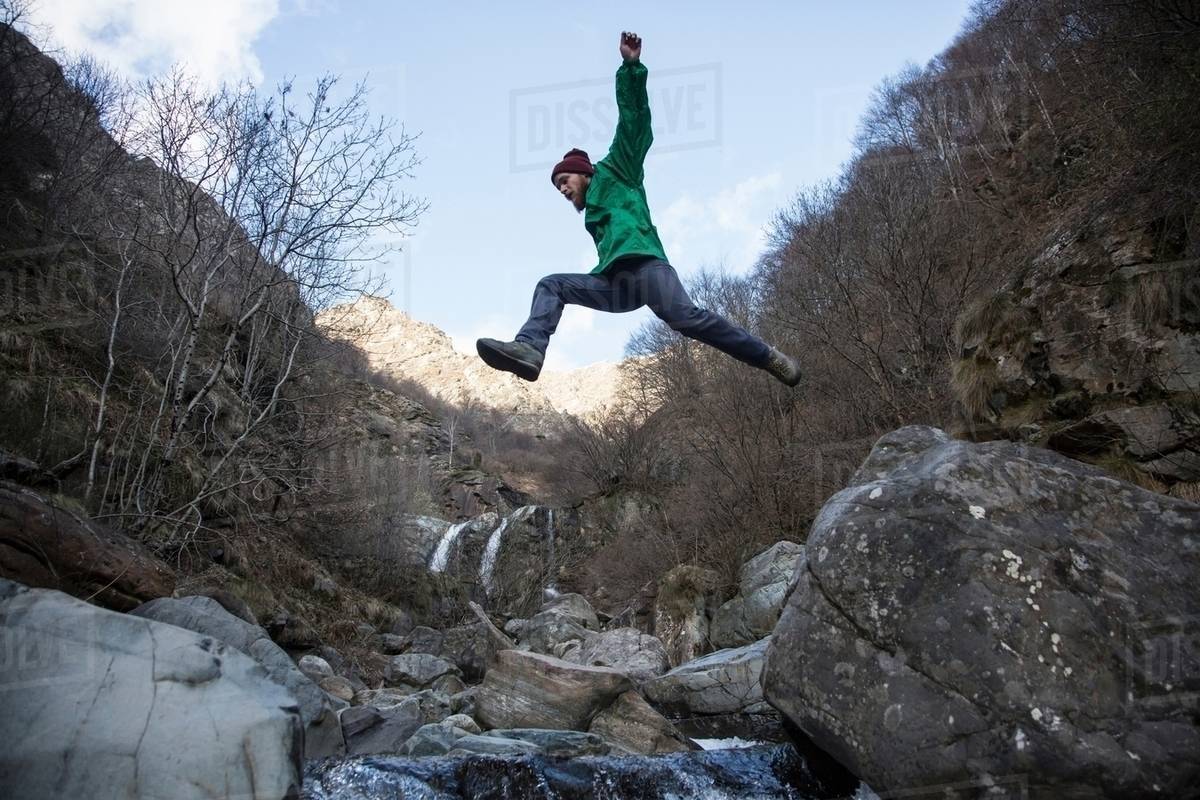 Man jumping over Toce River, Premosello, Verbania, Piedmonte, Italy ...