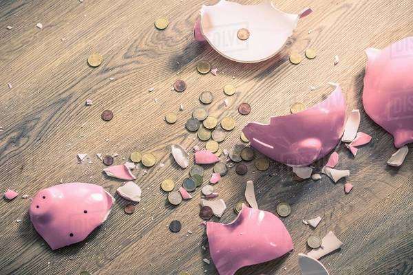 Broken piggy bank and coins - Stock Photo - Dissolve