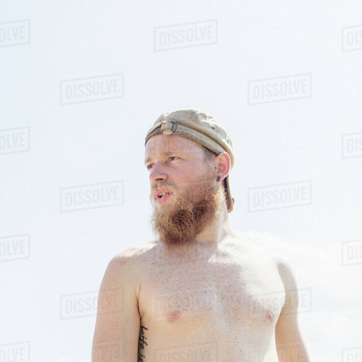 Bearded bare chested man looking away - Stock Photo - Dissolve