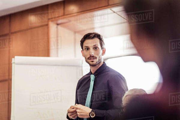 Businessman questioning at boardroom presentation - Stock Photo - Dissolve