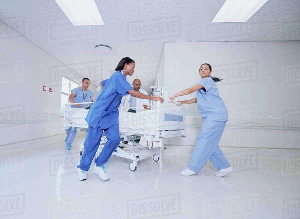 Doctor and medical running with patient bed in hospital emergency ...