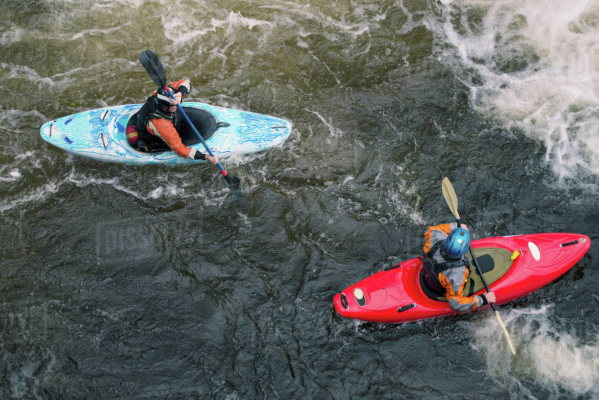 Overhead view of two kayakers paddling River Dee rapids - Royalty-free ...