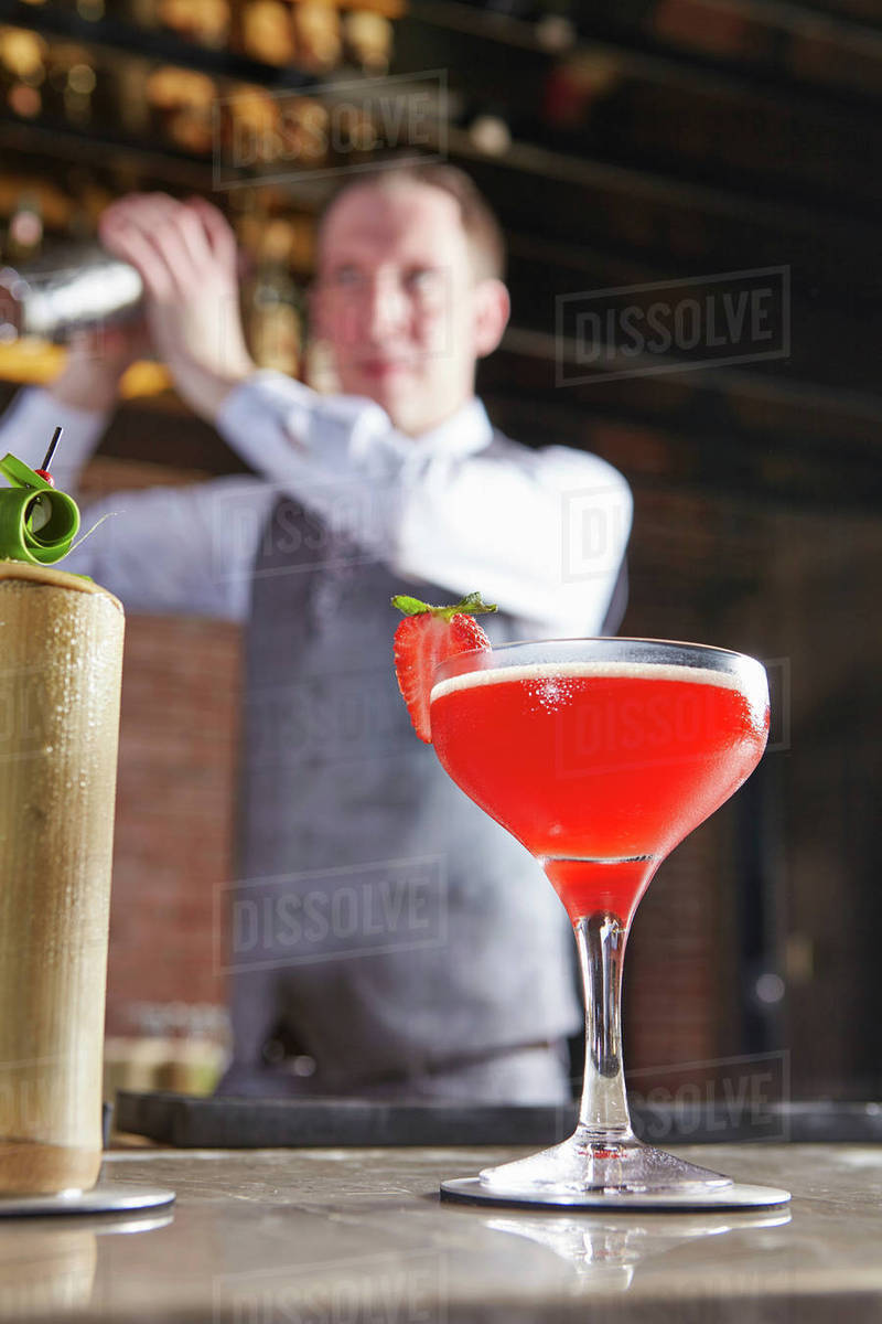 Bartender shaking cocktail shaker - Royalty-free Stock Photo | Dissolve