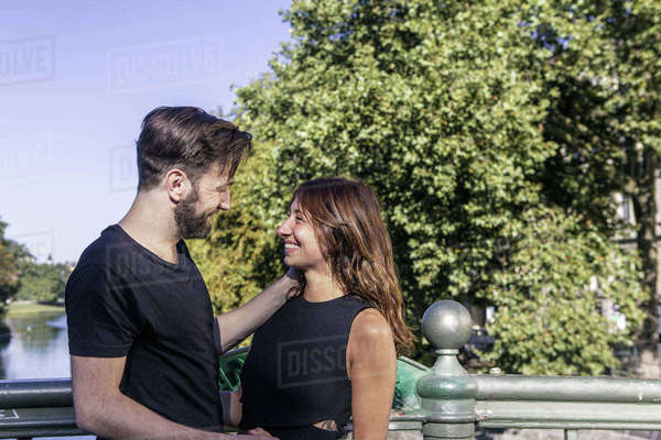 Couple on bridge face to face smiling, Berlin, Germany - Royalty-free ...