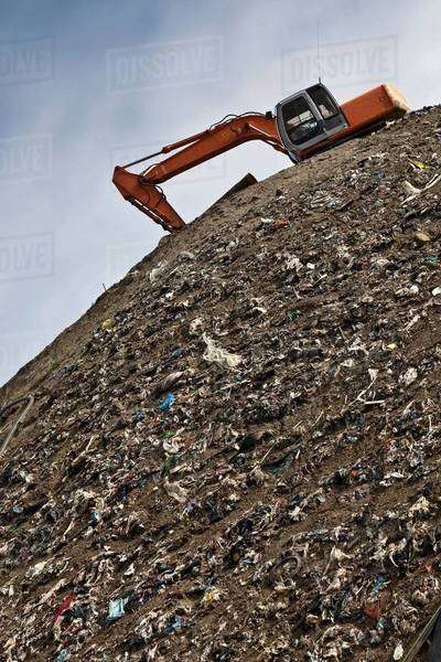 Digger at garbage collection center - Royalty-free Stock Photo | Dissolve