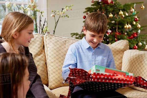 Children opening Christmas gifts - Royalty-free Stock Photo | Dissolve
