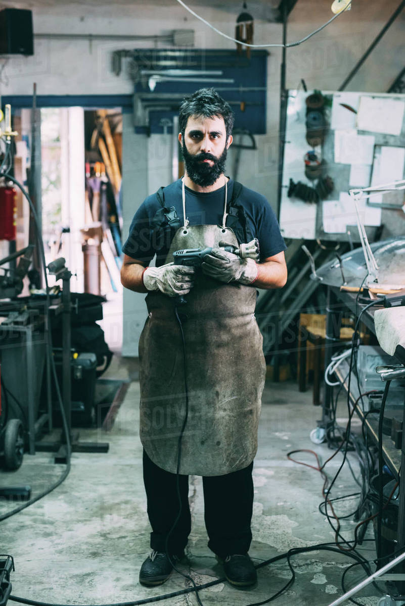 Portrait of male metalworker in apron, forge workshop - Royalty-free ...