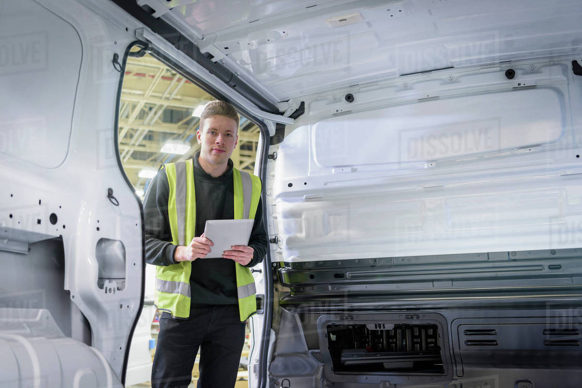 Apprentice vehicle inspector inspecting interior of vehicle in car ...