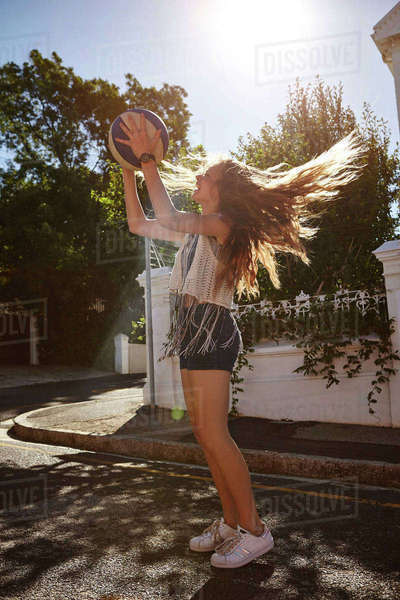 Teenage girl catching ball in street, Cape Town, South Africa - Royalty ...