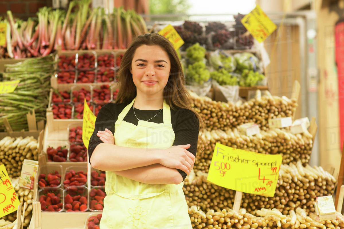 Portrait of young female fruit and veg stall trader - Royalty-free ...
