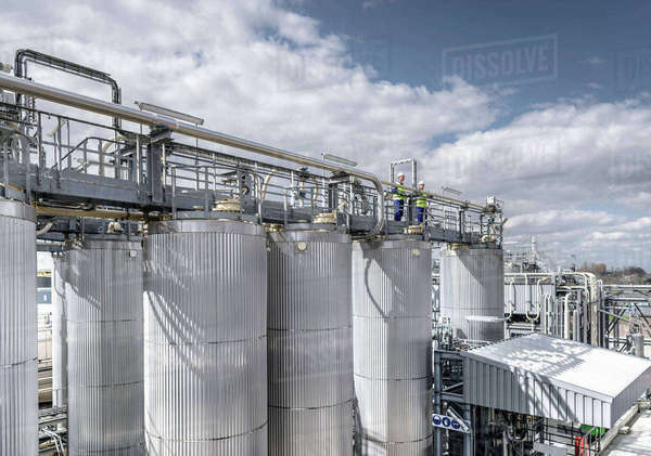 Workers on top of process plant in oil blending factory - Stock Photo ...
