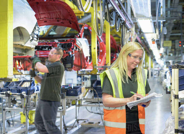 Female car parts inspector on production line in car factory - Stock ...