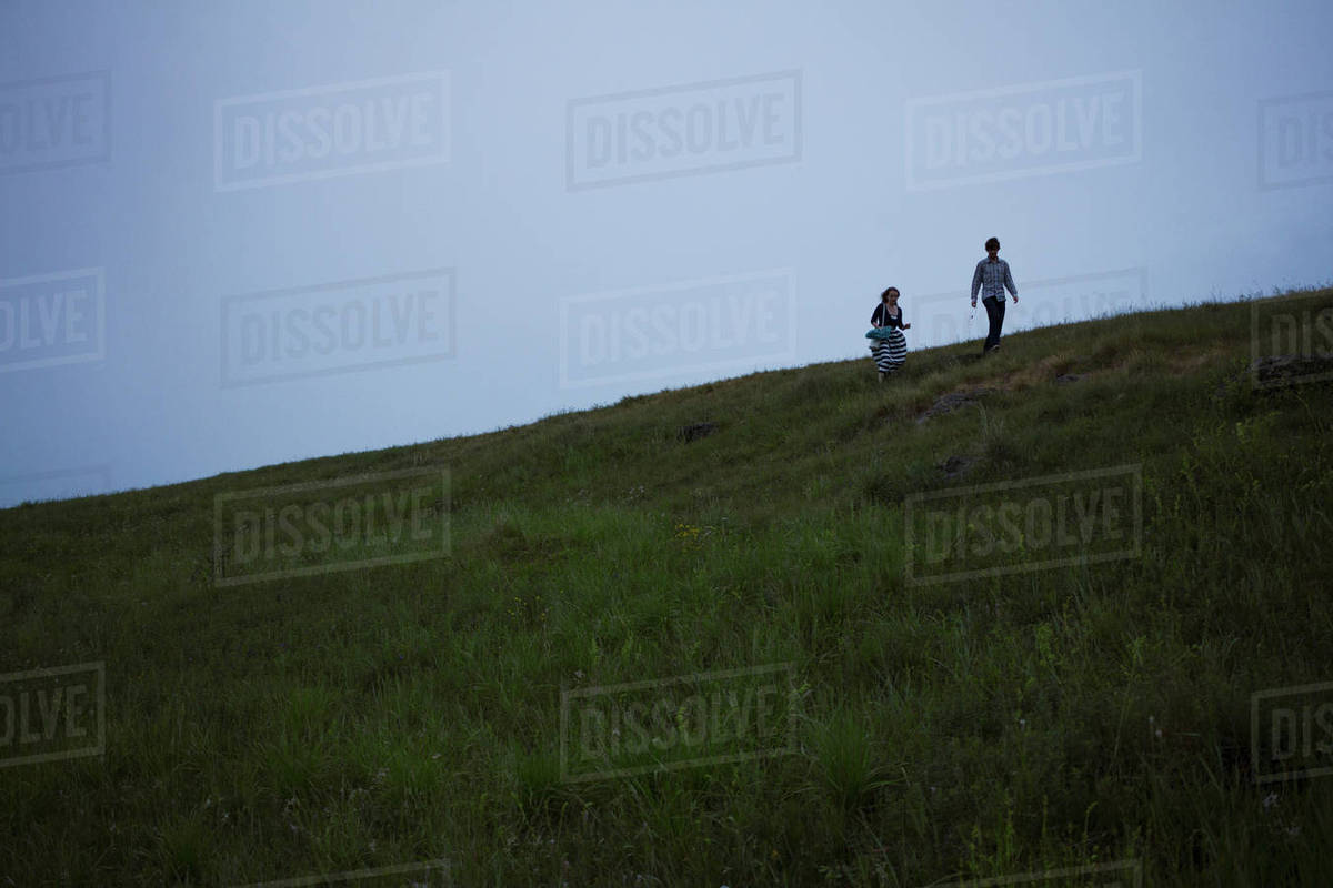 Couple strolling through countryside - Royalty-free Stock Photo | Dissolve