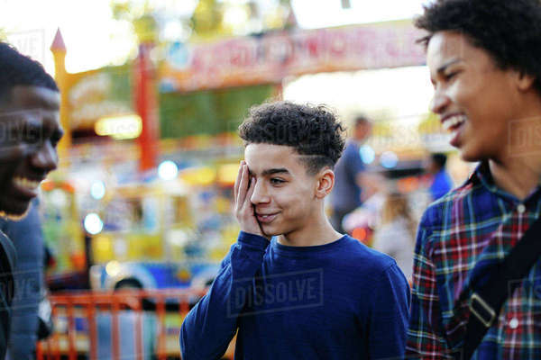 Three boys at funfair, laughing - Stock Photo - Dissolve