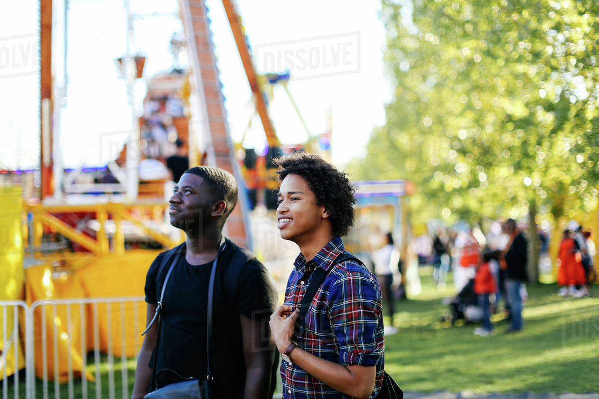 Two male friends at funfair, smiling - Royalty-free Stock Photo | Dissolve