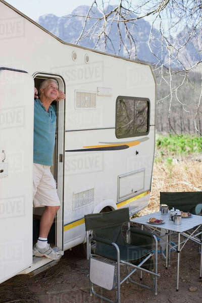 Older man at door of RV - Stock Photo - Dissolve