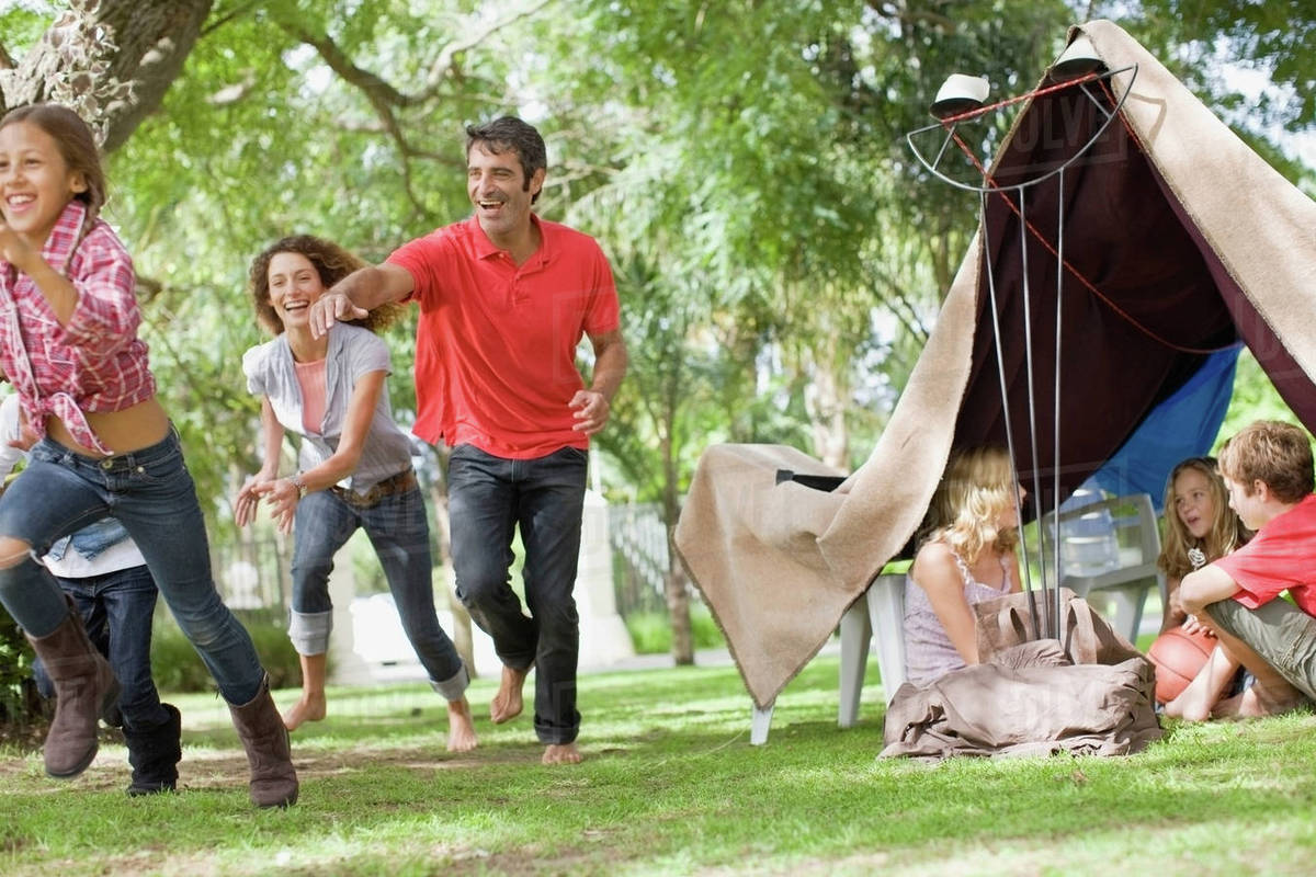 Family playing together in backyard - Royalty-free Stock Photo | Dissolve