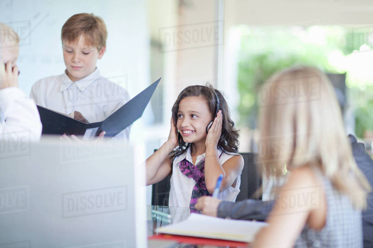 Children playing business people at desk - Stock Photo - Dissolve