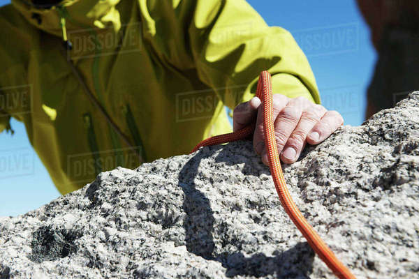 Mountaineer holding rope, close up - Stock Photo - Dissolve