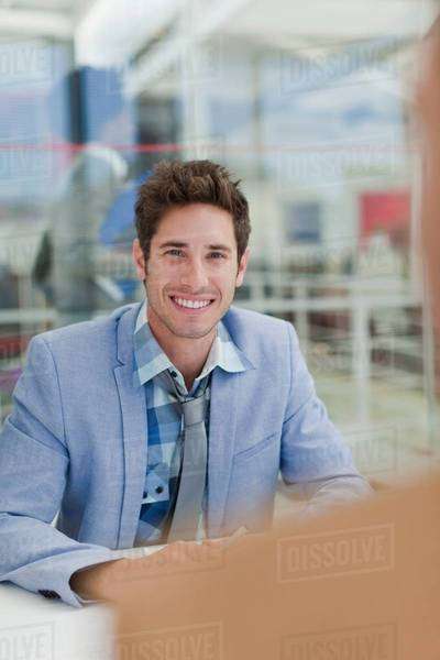 Businessman smiling in meeting - Royalty-free Stock Photo | Dissolve