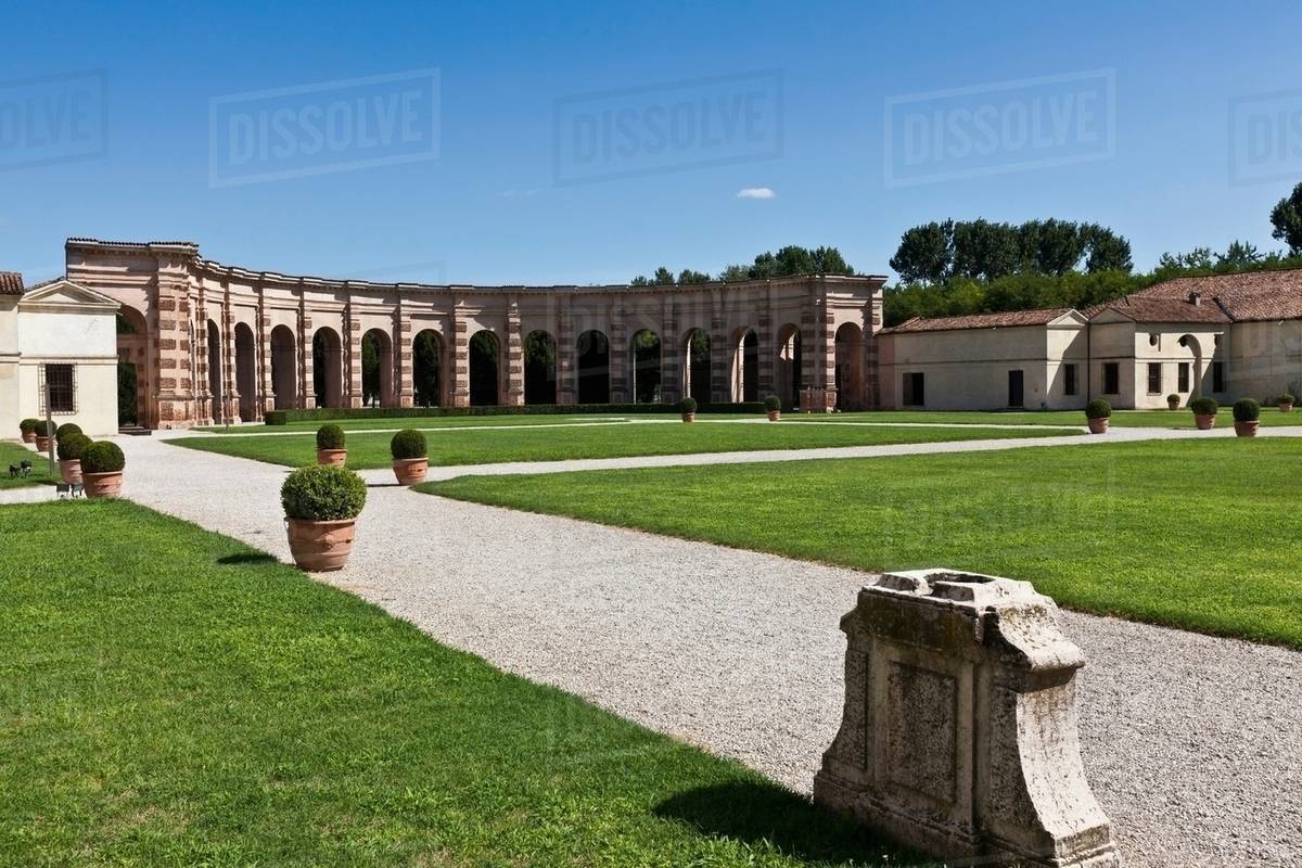 Colonnade with manicured gardens - Stock Photo - Dissolve