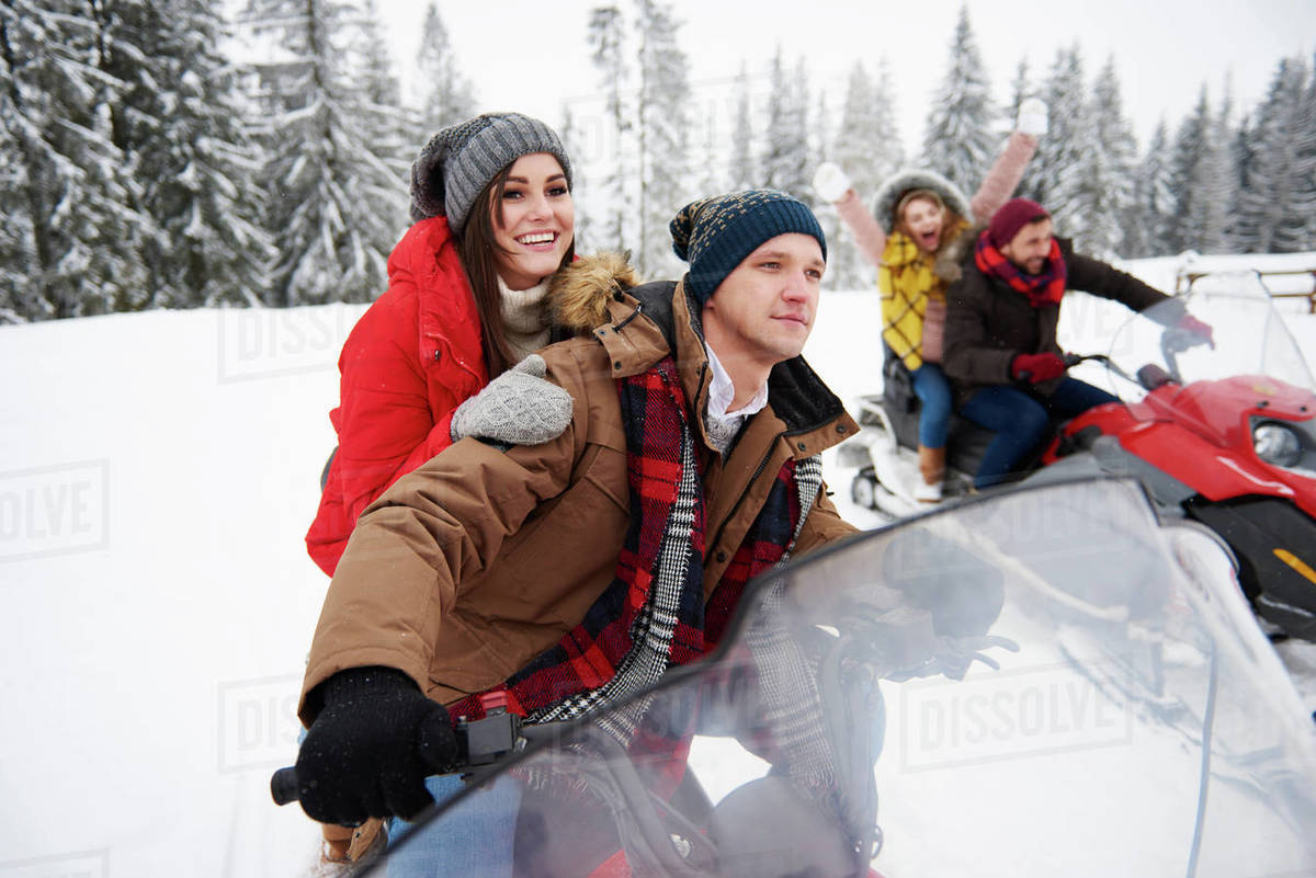 Friends riding snowmobiles in winter - Royalty-free Stock Photo | Dissolve