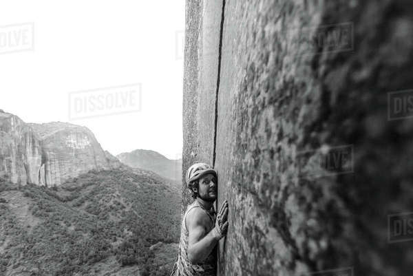 Rock climber climbing sandstone rock, Liming, Yunnan Province, China ...