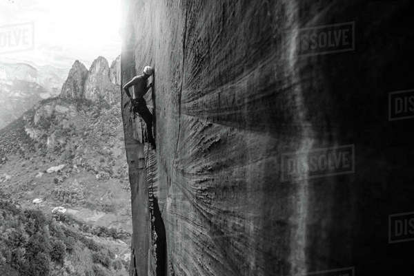Rock climber climbing sandstone rock, Liming, Yunnan Province, China ...