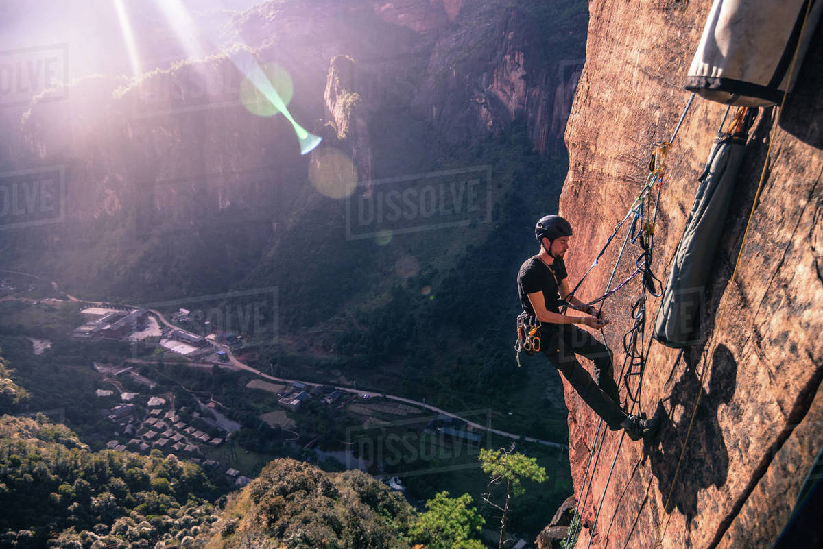 Rock climber climbing sandstone rock, elevated view, Liming, Yunnan ...