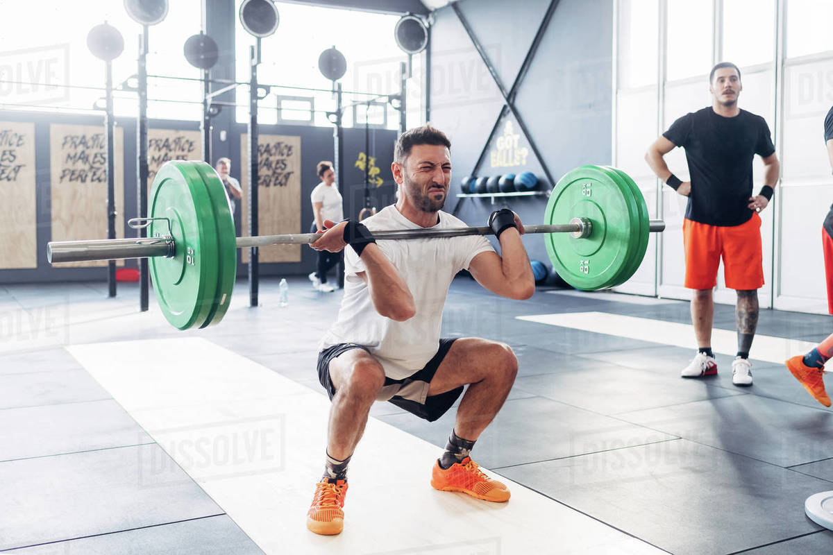 Man weightlifting barbell in gym - Royalty-free Stock Photo | Dissolve