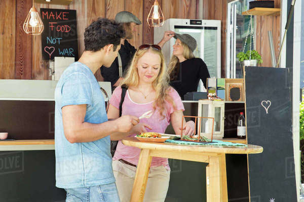 Customers enjoying meal at food truck - Stock Photo - Dissolve