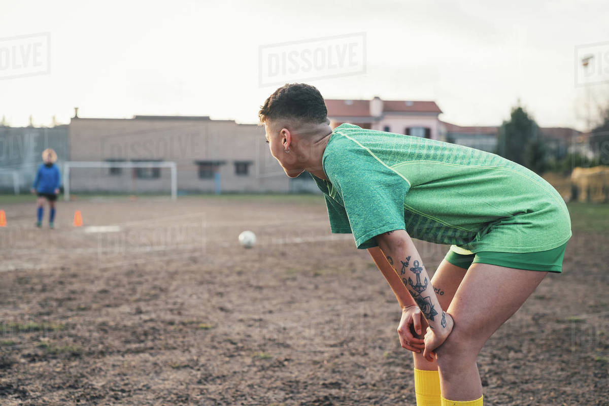 Football players waiting on pitch - Royalty-free Stock Photo | Dissolve