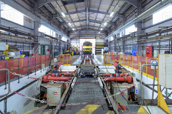 Locomotive approaching wheel lathe machine in train engineering factory ...