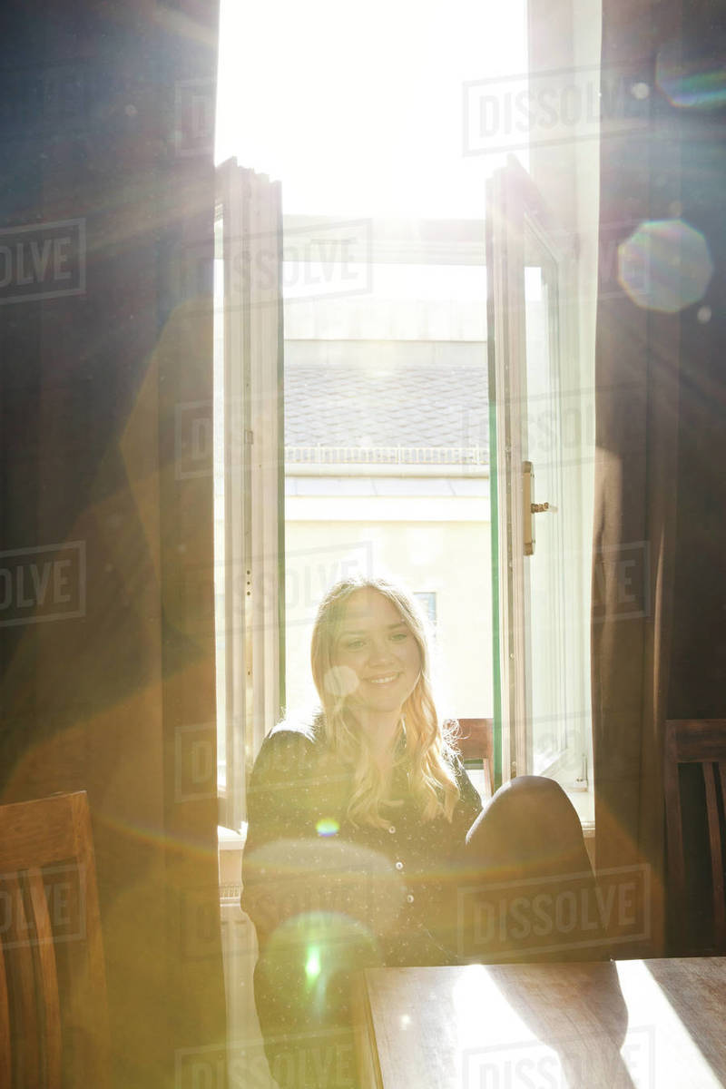Woman relaxing by window - Stock Photo - Dissolve